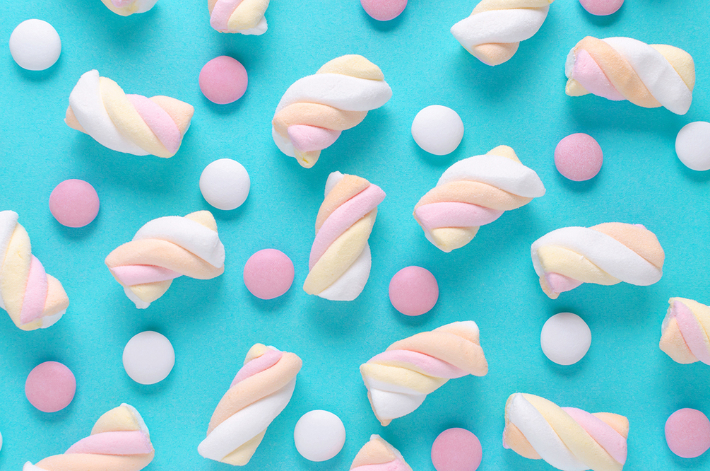 Photo "marshmallow and candy, abstract pattern on blue background"