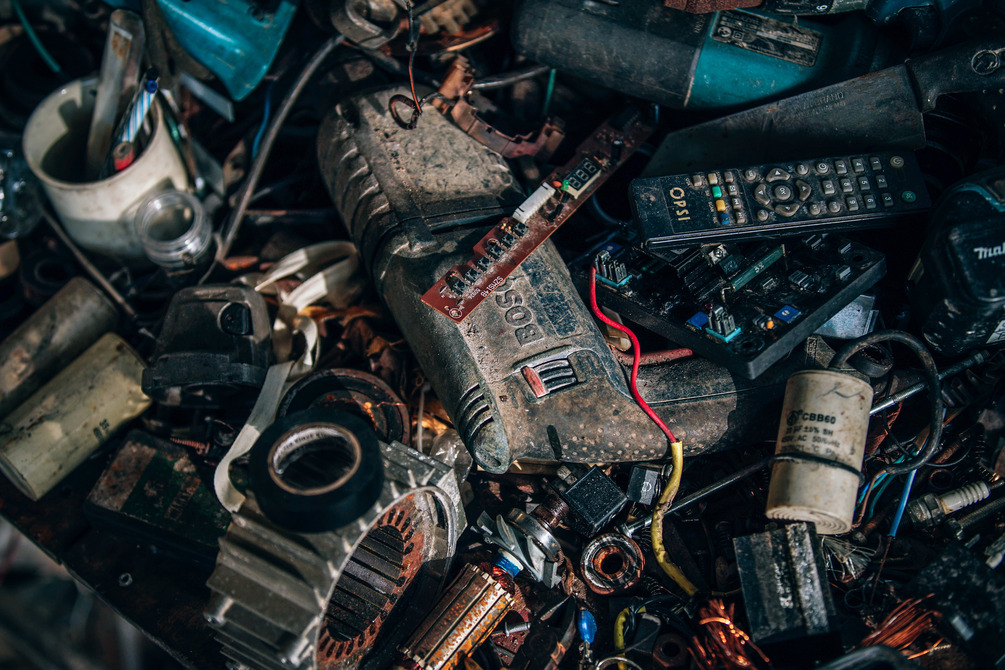 Messy Power Tools, Batteries, and Remote Controllers on a Table (6000 x ...