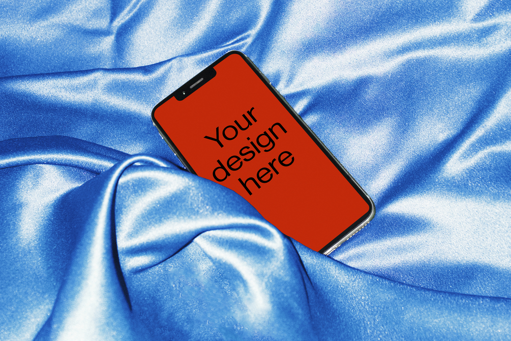 iPhone mockup on a blue silk fabric