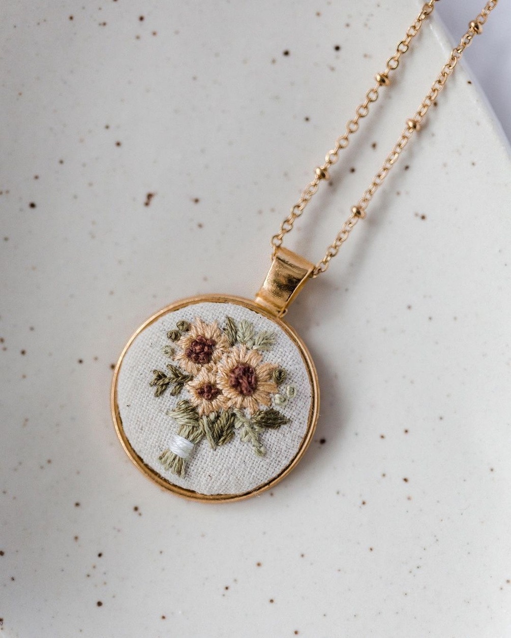 Hand embroidered pendant