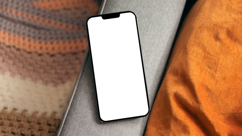 Free iPhone 14 Pro Laying On Couch Mockup