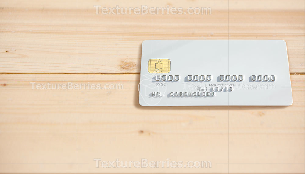 Blank white bank card on wooden table background