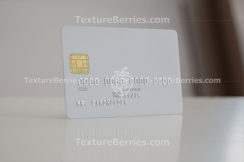 White blank bank card on soft blurred background