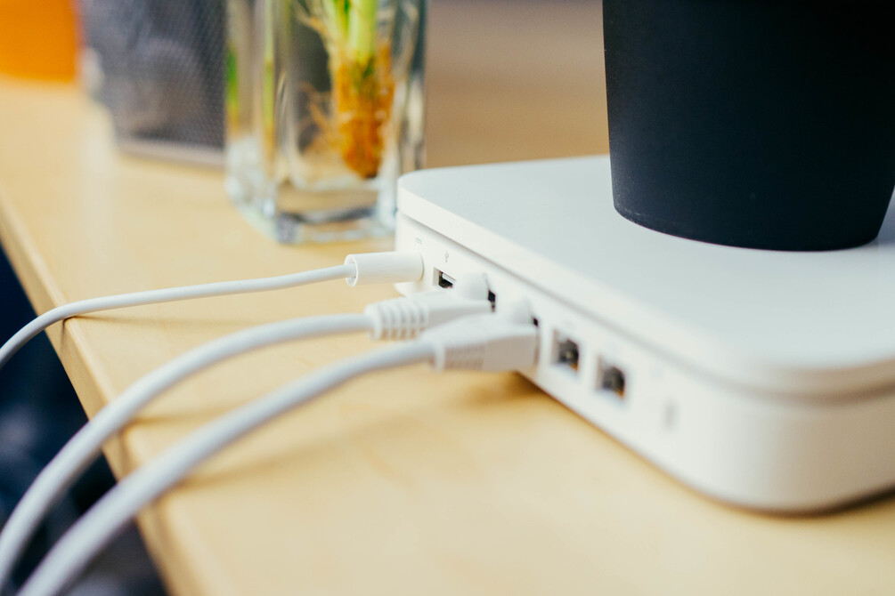 White Wireless Apple Router Connected With Ethernet Cords (4621 x 3081px)