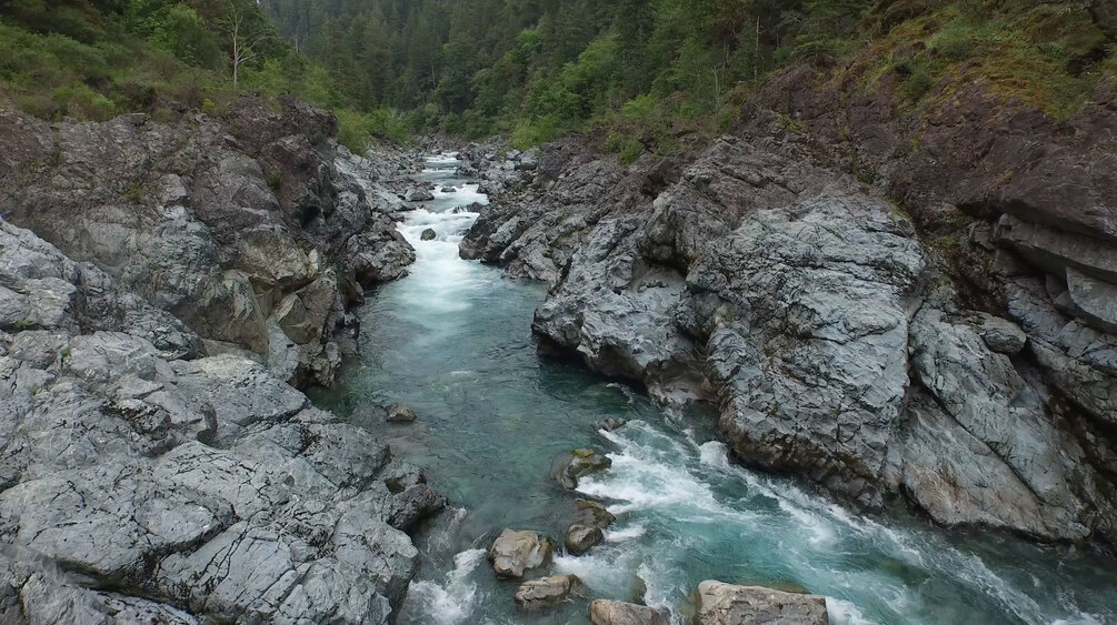 Flying over a river rapids | 4K