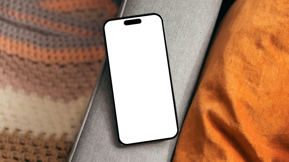 Free iPhone 14 Pro Laying On Couch Mockup