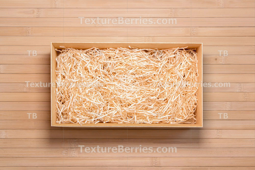 Wine box with decorative filler on bamboo, top view