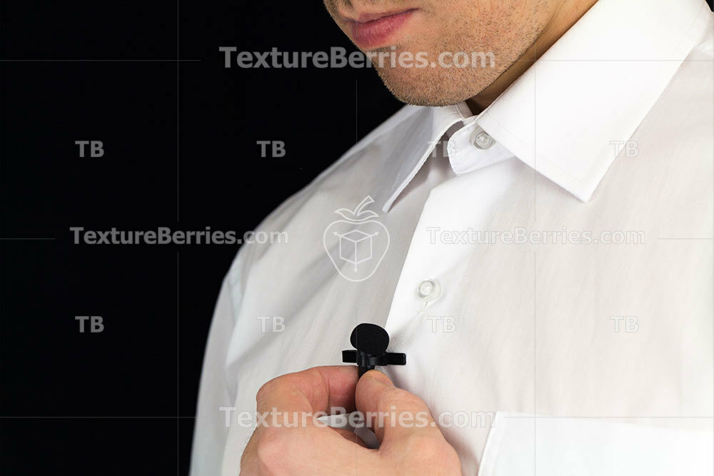 Man holds lavalier microphone, preparation for interview