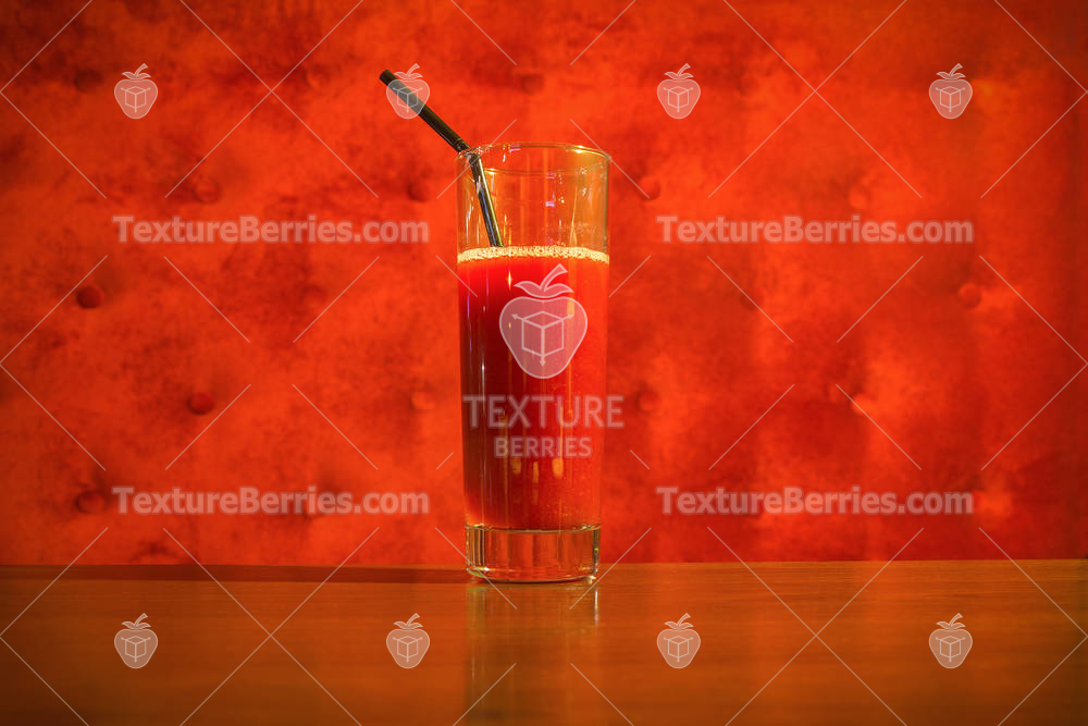 Fresh red juice on red background