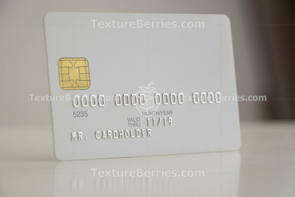 White blank bank card on blurred background