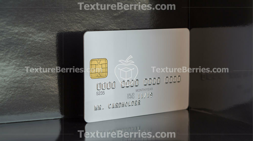 White bank card with reflections on dark background