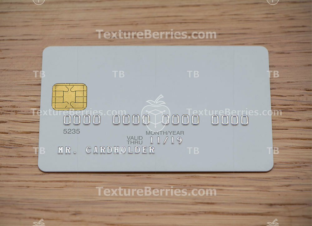 Blank white bank card on wooden table