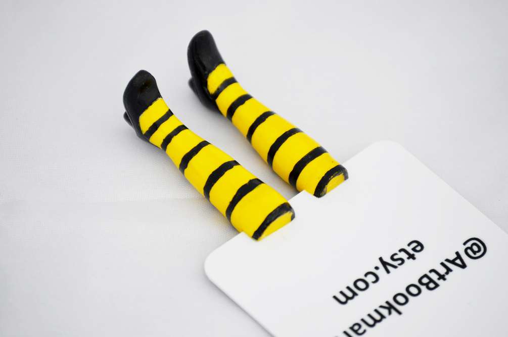 Bookmark legs in yellow striped socks.